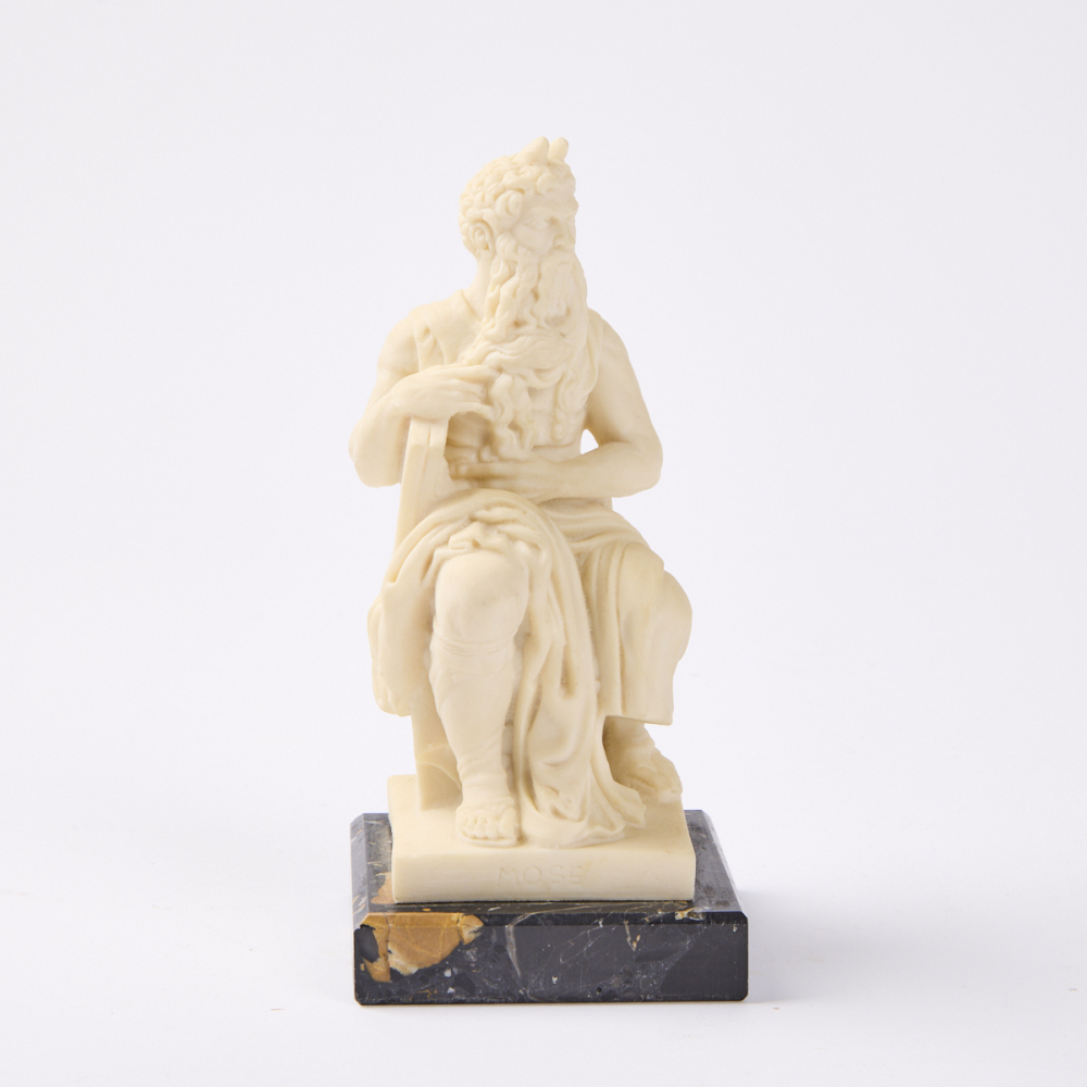 A Small Moses Sculpture On Marble