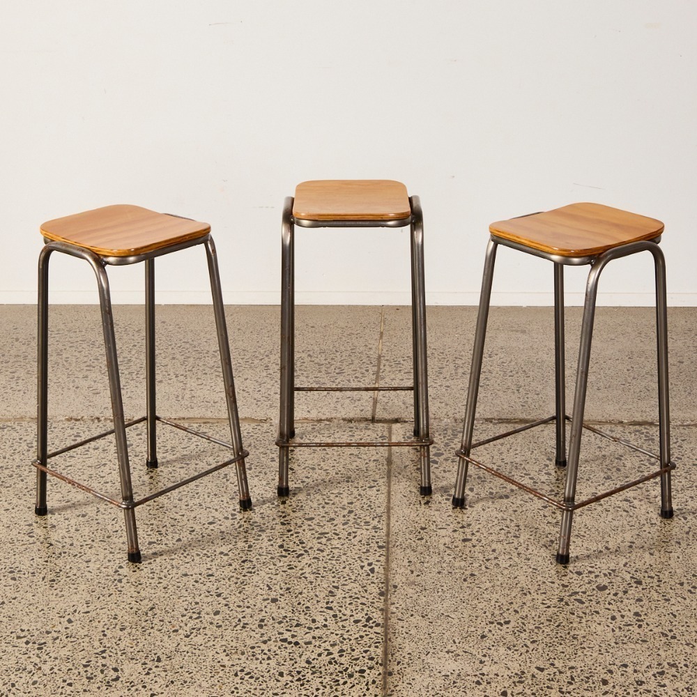 A Collection Of Three Industrial Lab Bar Stools