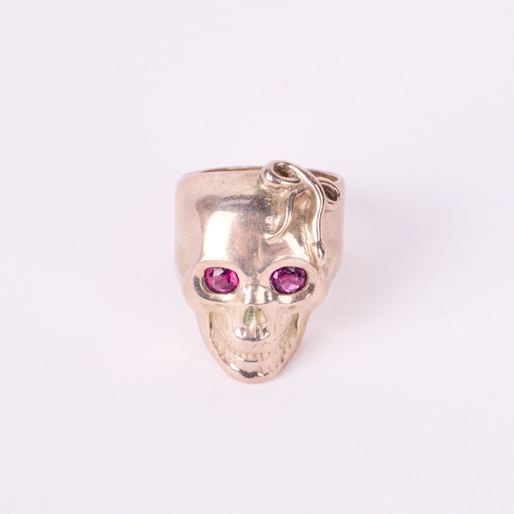 A Sterling Silver Meadowlark Bow Skull Ring With Amethyst Eyes